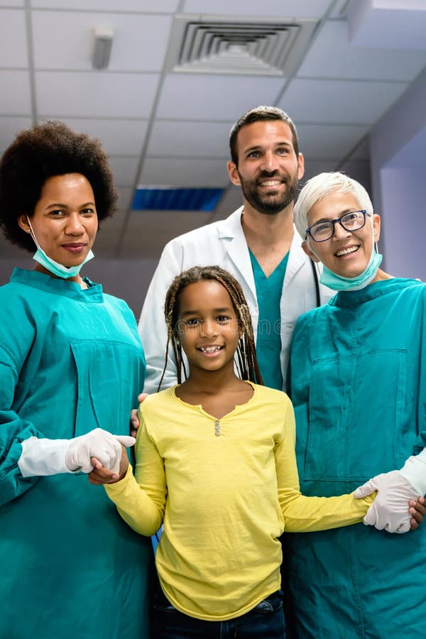 Team of Experienced Highly Qualified Doctors with Child Patient after a ...