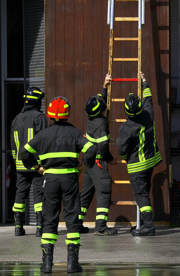 Team of Firefighters with Leader with Red Helmet during an Emergency ...