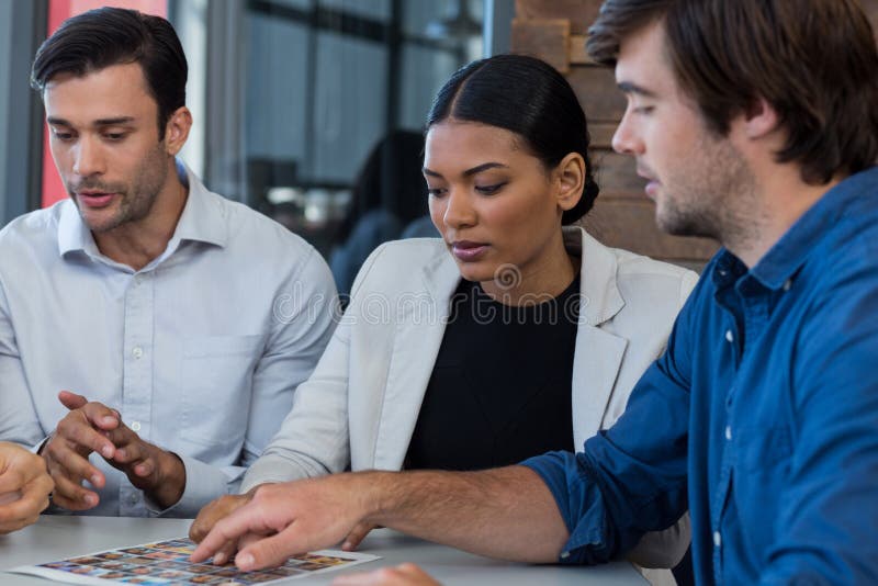 Team of Graphic Designers Discussing Over Photos Stock Photo - Image of ...