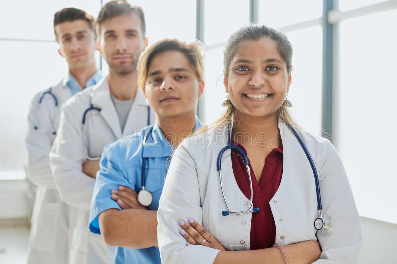 Successful Team of Medical Doctors are Looking at Camera and Smiling ...