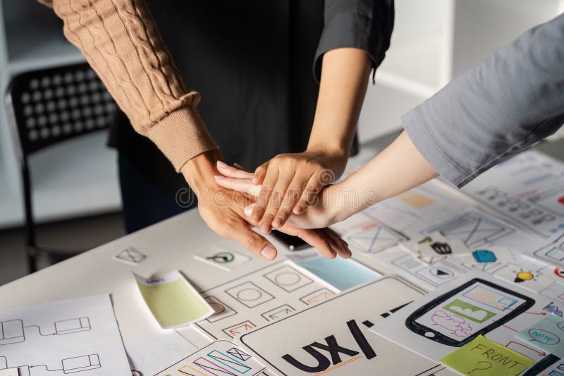 Team Joining Hands in Solidarity during UX UI Design Collaboration ...