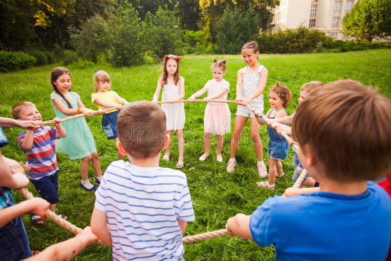 Team of Kids Performs a Sports Task with a Rope Stock Photo - Image of ...