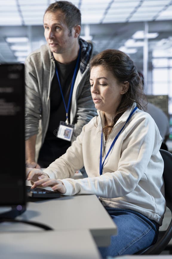 Team Leader Overseeing Employee Coding on Computer in Server Room Stock Photo - Image of ...