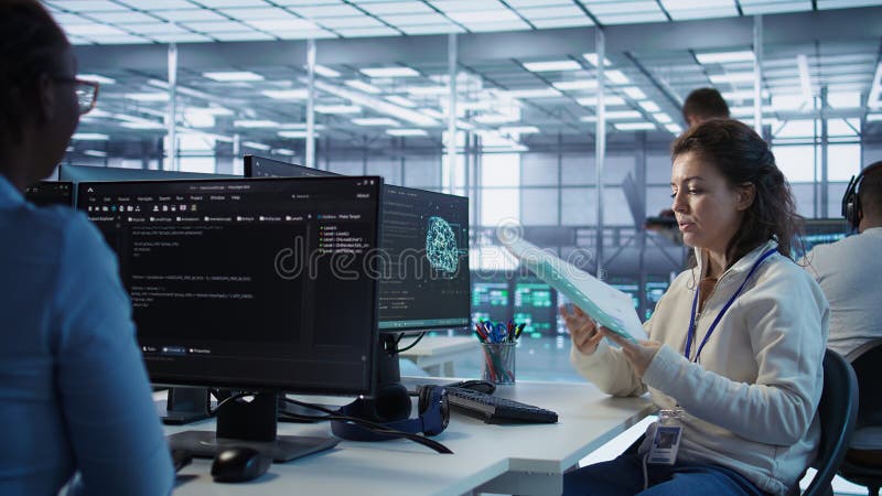 Team Leader Reading Paperwork Files on Artificial Intelligence Tech Stock Photo - Image of ...