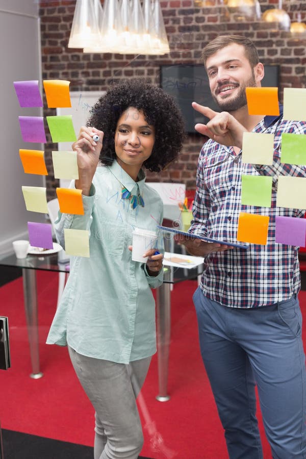 Team Looking at Sticky Notes on Window Stock Image - Image of ...