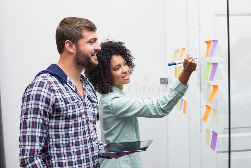 Team Looking at Sticky Notes on Window Stock Image - Image of ...