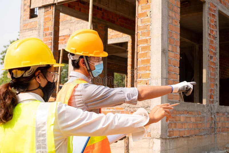 A Team of Male and Female Engineers or Architects is Exploring and ...