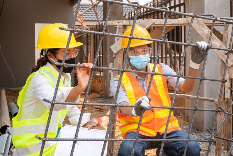 A Team of Man and Female Engineers or Architects is Exploring and ...