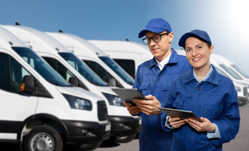 Team of Managers with a Digital Tablets on the Background of Trucks ...