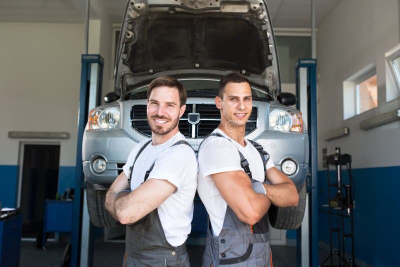 Team of mechanics stock image. Image of looking, happy - 75369509