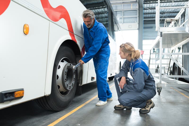 Team Mechanics Working at Garage Stock Photo - Image of young, happy ...