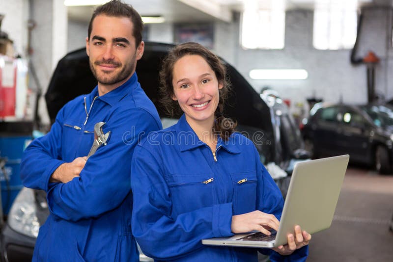 Team of Mechanics Working at the Garage Stock Image - Image of happy ...