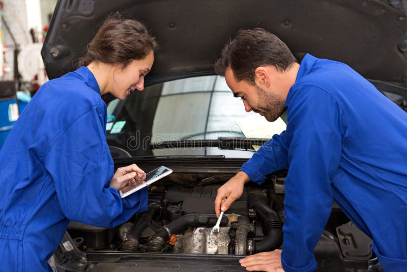 Team of Mechanics Working at the Garage Stock Photo - Image of smiling ...