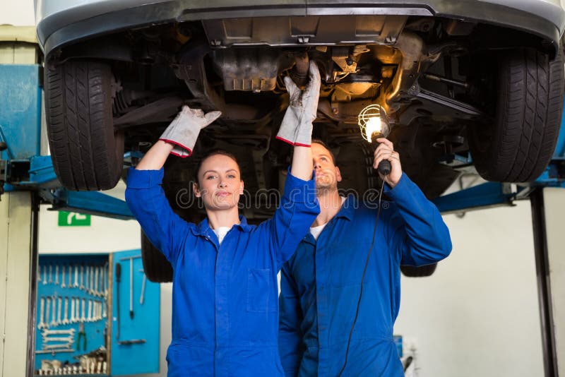 Team of Mechanics Working Together Stock Photo - Image of blue, torch ...