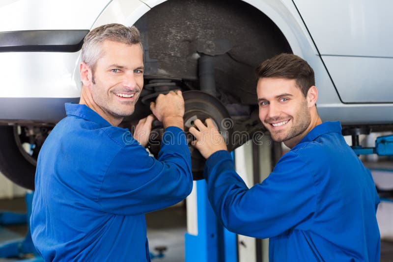 Team of Mechanics Working Together Stock Image - Image of automobile ...