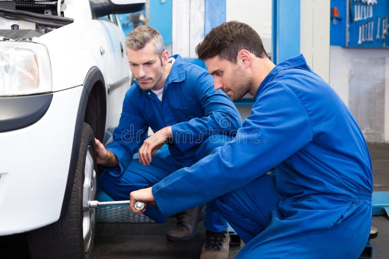 Team of Mechanics Working Together Stock Image - Image of repairing ...