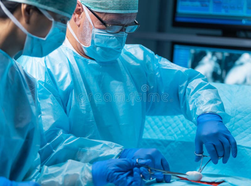 Team of Medical Doctors Performs Surgical Operation in Modern Operating ...
