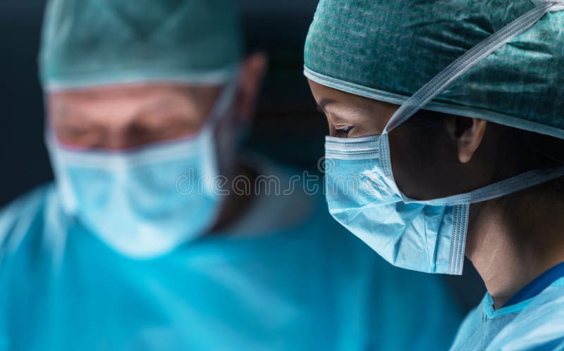 Team of Medical Doctors Performs Surgical Operation in Modern Operating ...