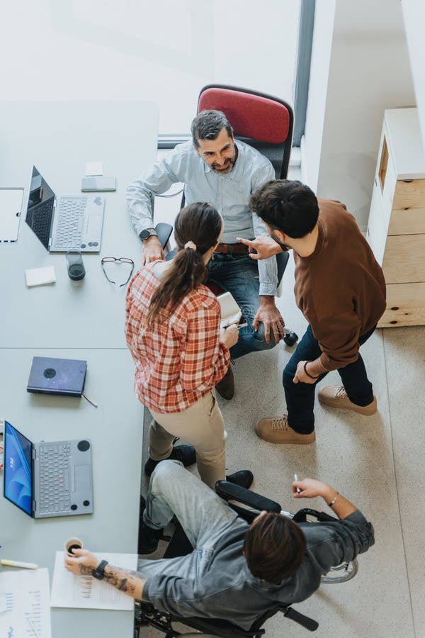 Team Meeting Discussion with Laptops and Documents in Modern Office ...