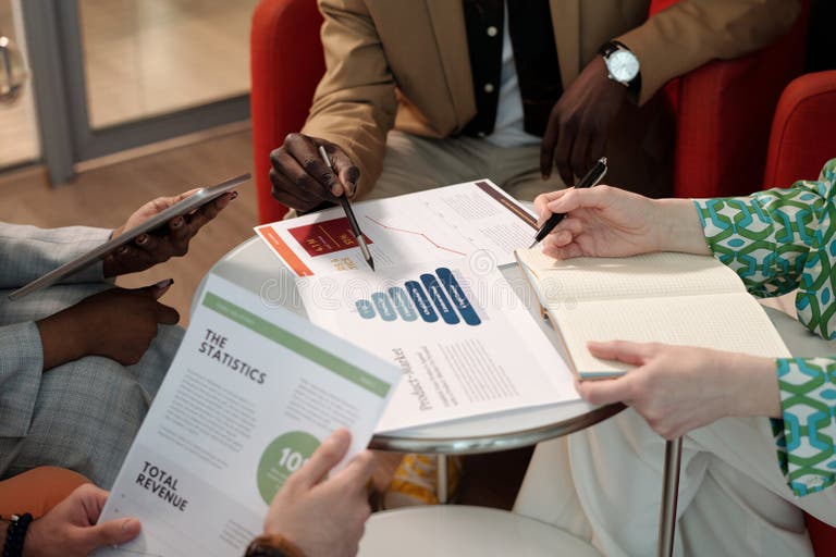 Team Members Analyzing Data and Statistics Together Stock Image - Image ...