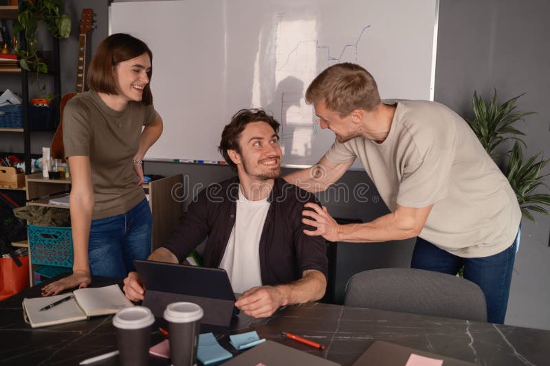 Team Members Collaborating in a Casual Office Atmosphere with a ...
