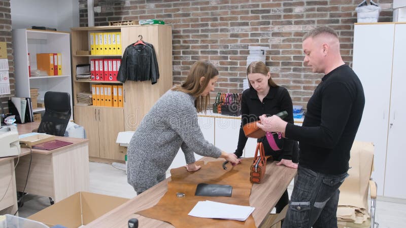 Team Members Collaborating on Project in Modern Office with Brick Wall ...