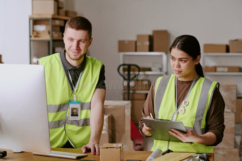 Team Members Collaborating in Warehouse Environment Stock Image - Image ...