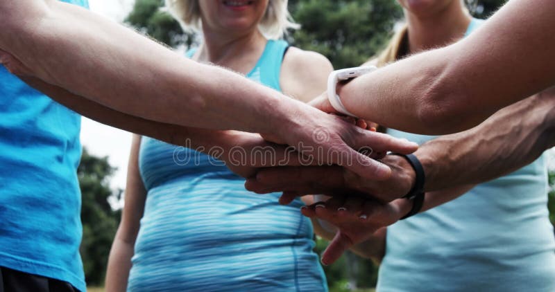 Team Members Stack Hands in a Show of Unity Outdoors Stock Photo ...