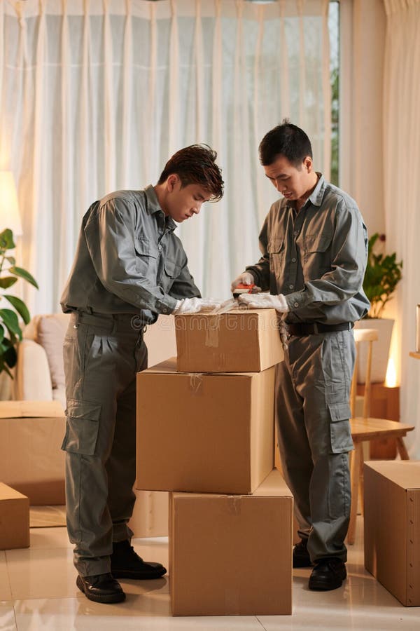 Team of Movers Packing Boxes Stock Image - Image of package, cardboard ...