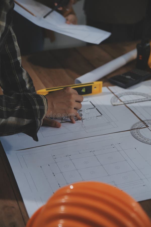 Team of Multiethnic Architects Working on Construction Plans in Meeting ...