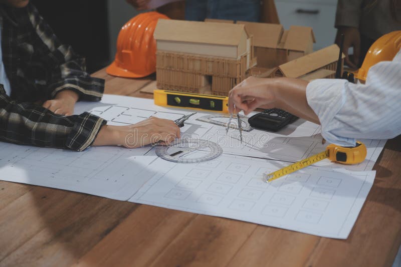 Team of Multiethnic Architects Working on Construction Plans in Meeting ...