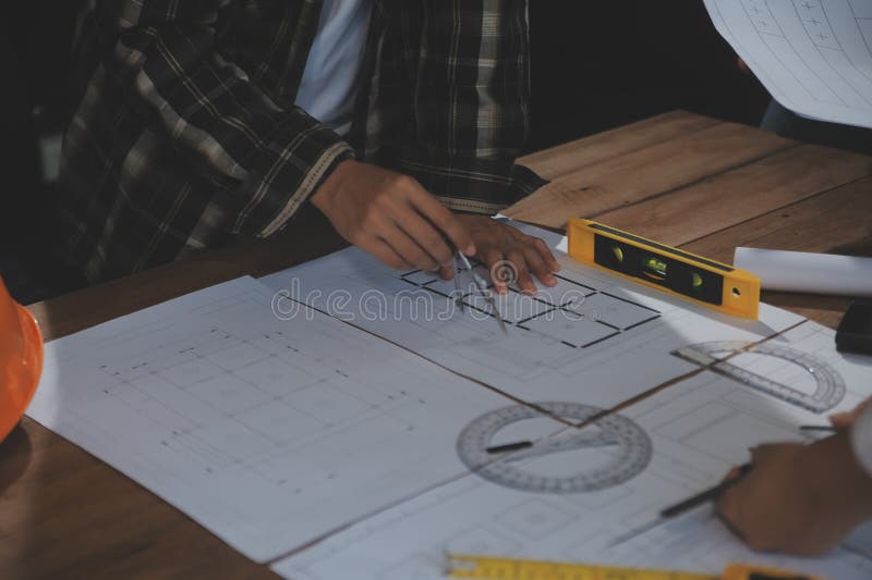 Team of Multiethnic Architects Working on Construction Plans in Meeting ...