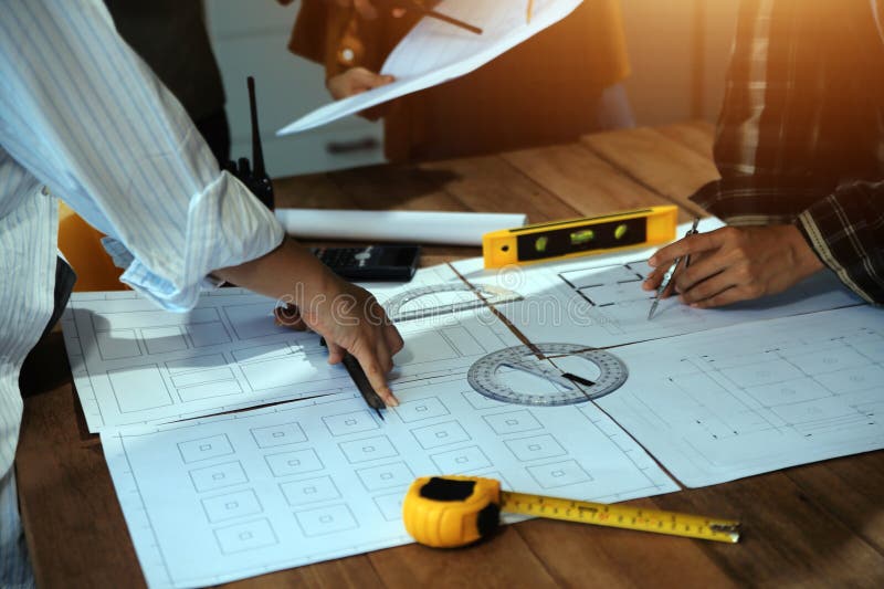 Team of Multiethnic Architects Working on Construction Plans in Meeting ...