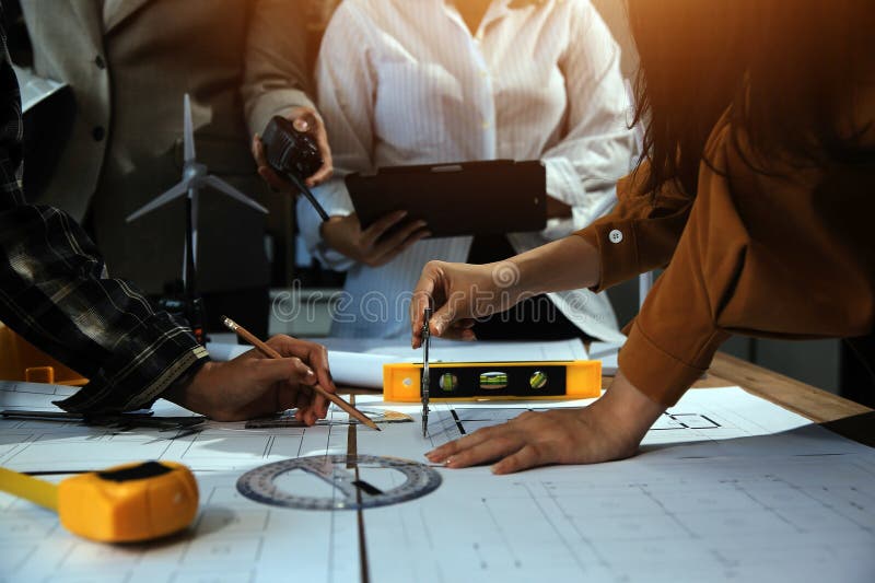 Team of Multiethnic Architects Working on Construction Plans in Meeting ...