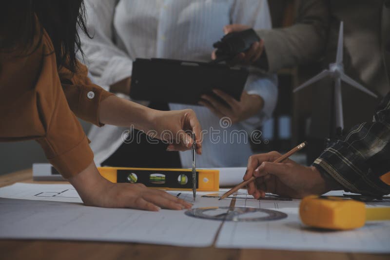 Team of Multiethnic Architects Working on Construction Plans in Meeting ...