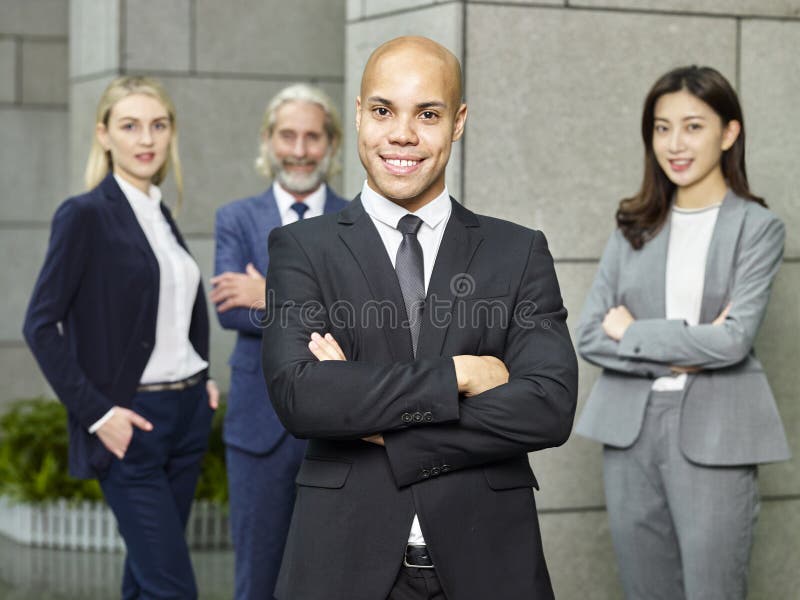 Team Of Multiethnic Business People Looking At Camera Smiling Stock