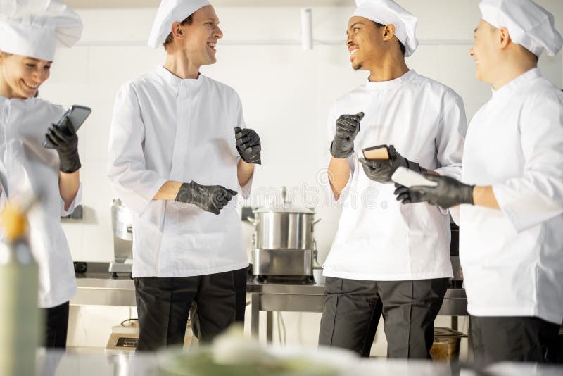 Team of Multiracial Cooks Having Conversation during a Coffee Break in ...