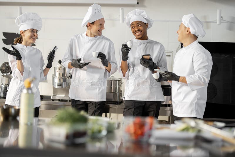 Team of Multiracial Cooks Having Conversation during a Coffee Break in ...