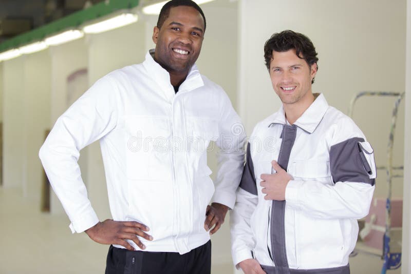 Team Painters Smiling at Camera Stock Photo - Image of paintbrush ...