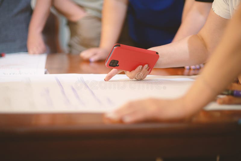 A Team of People Around a Table are Discussing What is Written on Paper ...