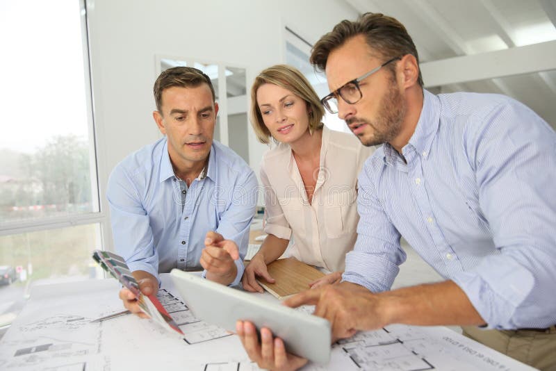 Architects in a Meeting Studying Plans Stock Photo - Image of manager ...