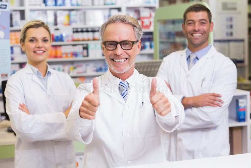 Team Of Pharmacists Smiling At Camera Stock Photo - Image: 49900990
