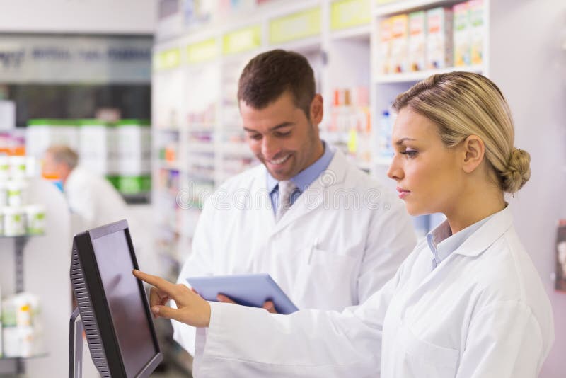 Team of Pharmacists Using Computer Stock Photo - Image of concentrating ...