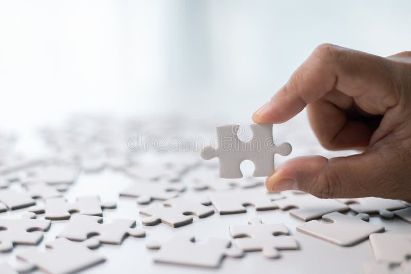 Team with Piece of Jigsaw Puzzle As Critical Component of Business ...