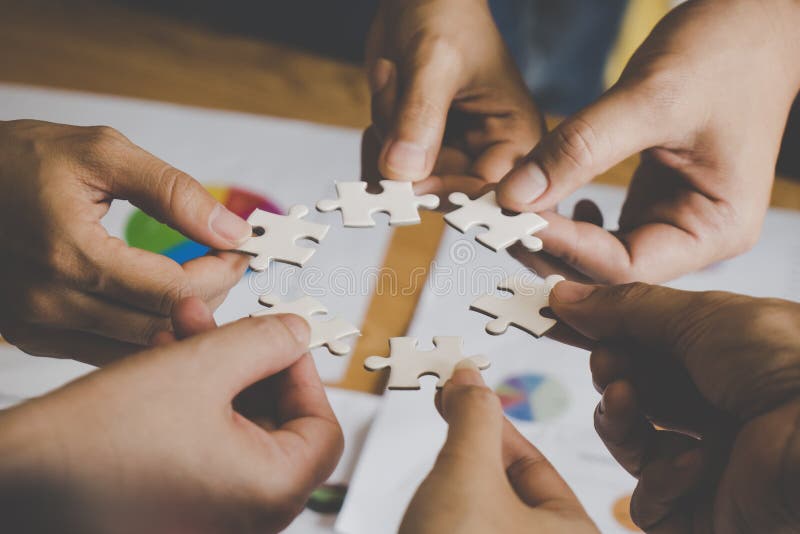 Team Placing Puzzles Jigsaw Together for Team Concept Stock Image ...