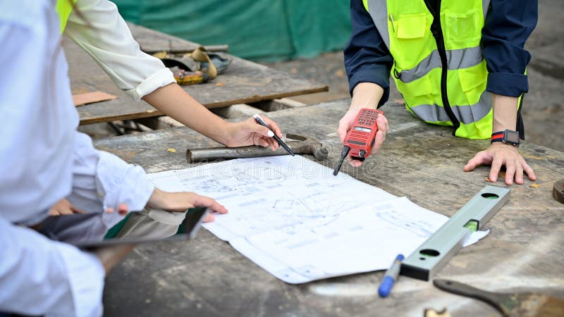 Team of Civil Engineer Looking at the Blueprint with Architect at the ...