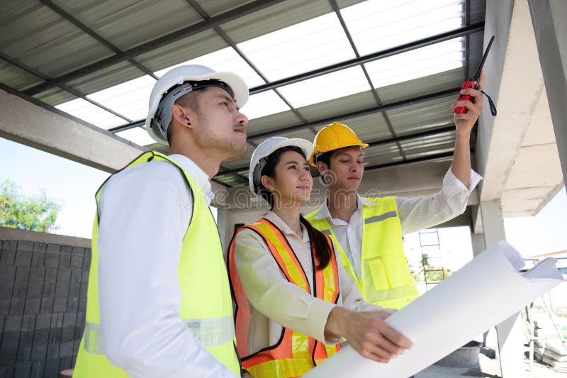 Team of Professional Civil Engineers and Architects Holding Project ...