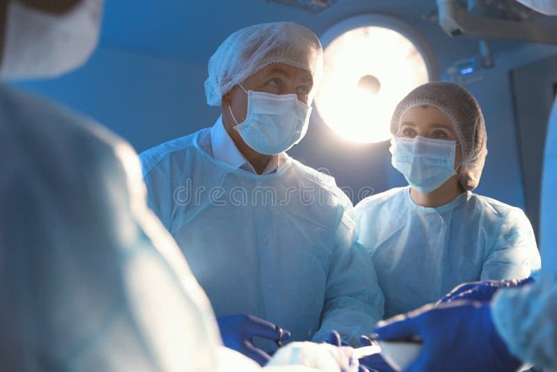 Team of Doctors Performing Operation in Surgery Room Stock Photo ...