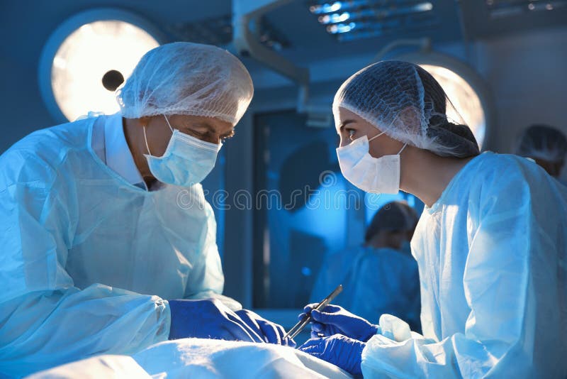 Team of Doctors Performing Operation in Surgery Room Stock Photo ...