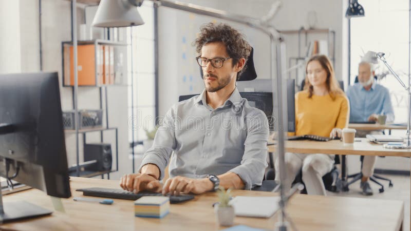 Team of Professional Office Employees Work on Desktop Computers ...